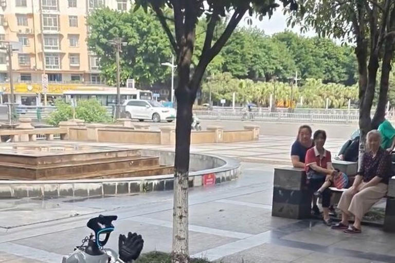 Robot spotted begging for cash on its knees in street after hitting ...