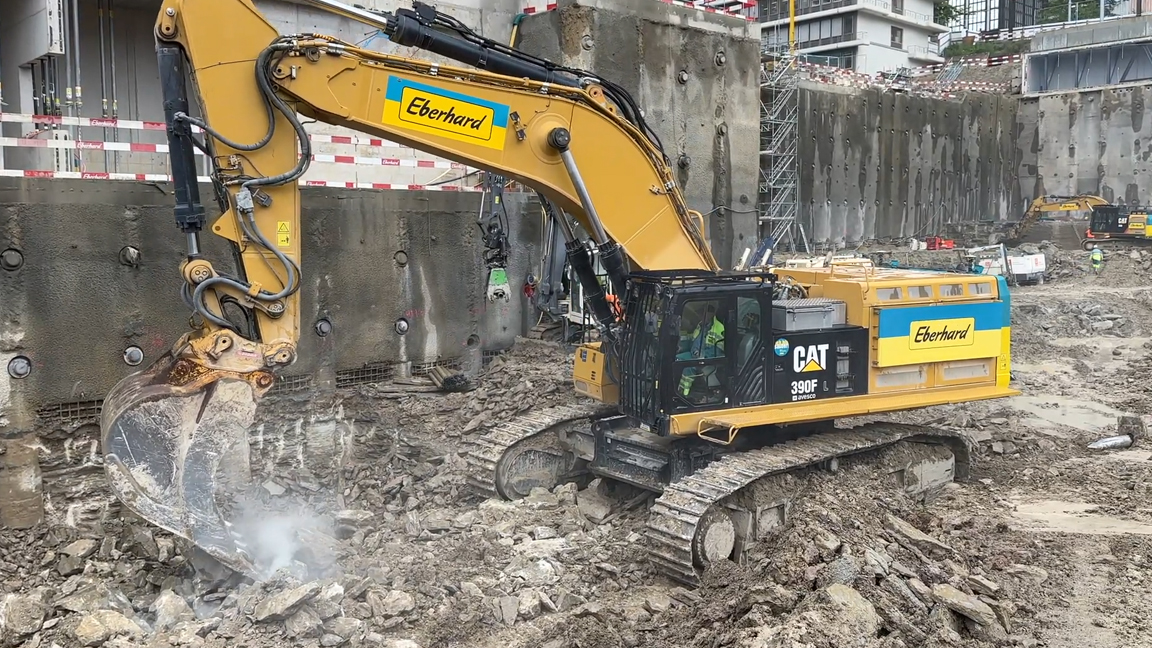 Watch this 90-ton excavator break through massive concrete structures