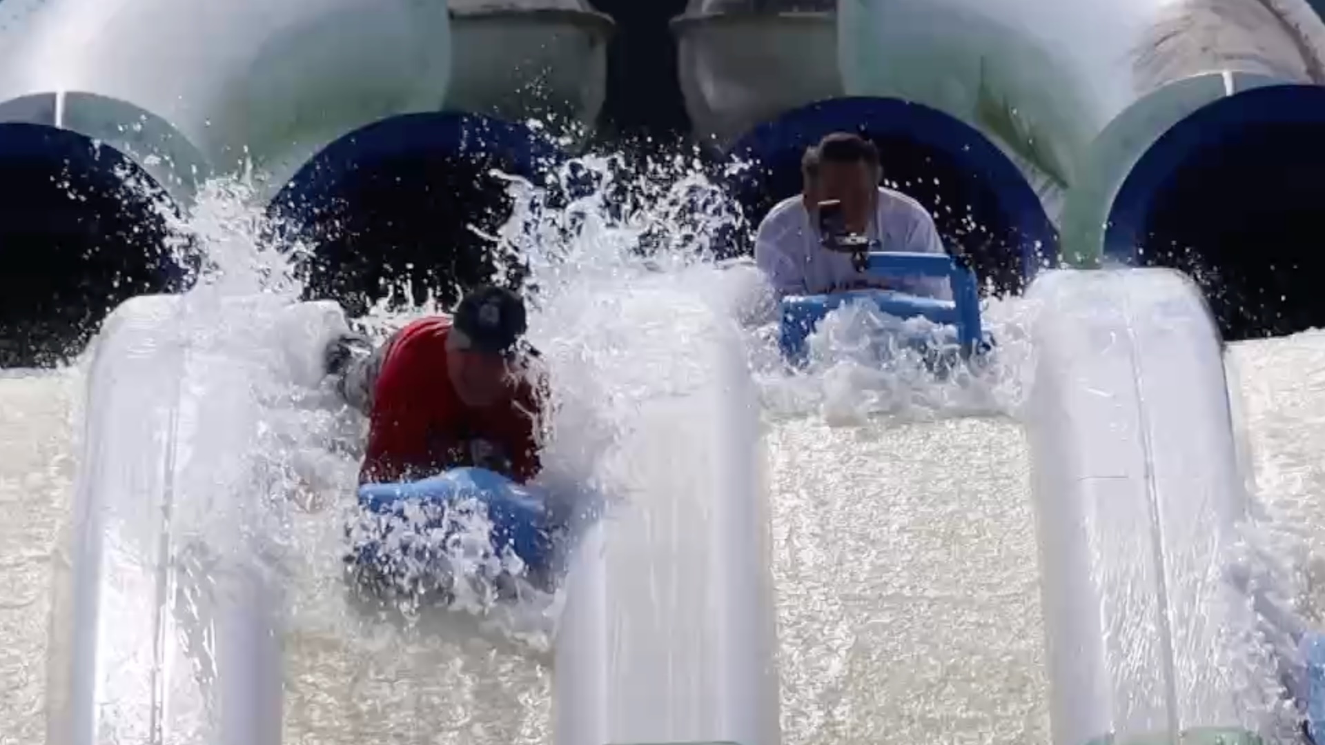 Meteorologist Walter Kelley and TA Walker race down slide at Rapids ...
