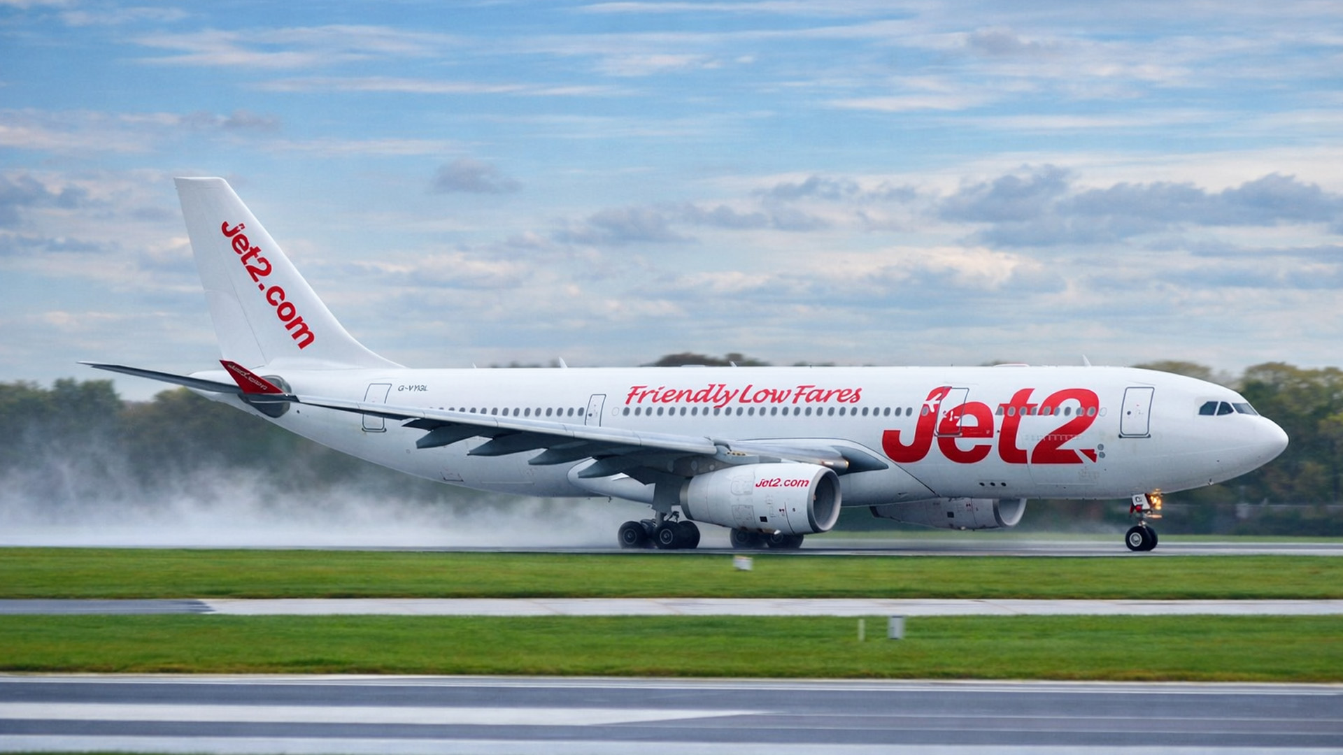 Jets blast through spray on wet runway