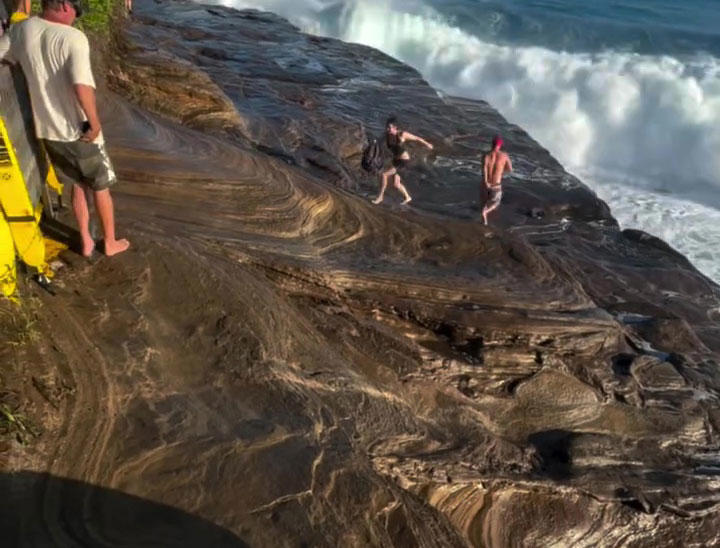 Rogue wave sweeps woman off infamous beach as frantic rescue caught on ...