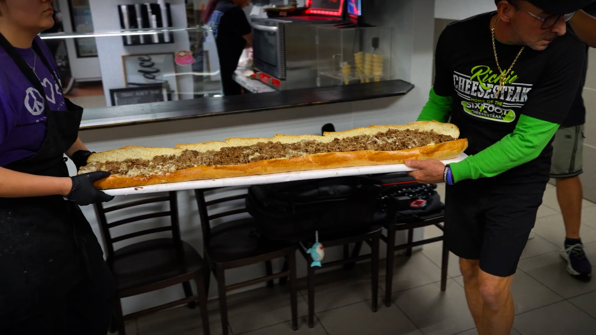 Man tries to eat a 4-foot cheesesteak bigger than the table for cash