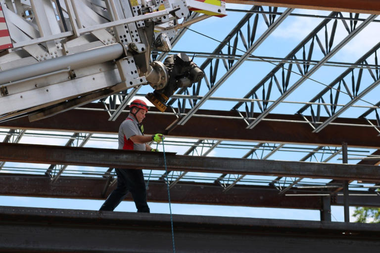 Photos: Person rescued after falling off construction site roof in ...