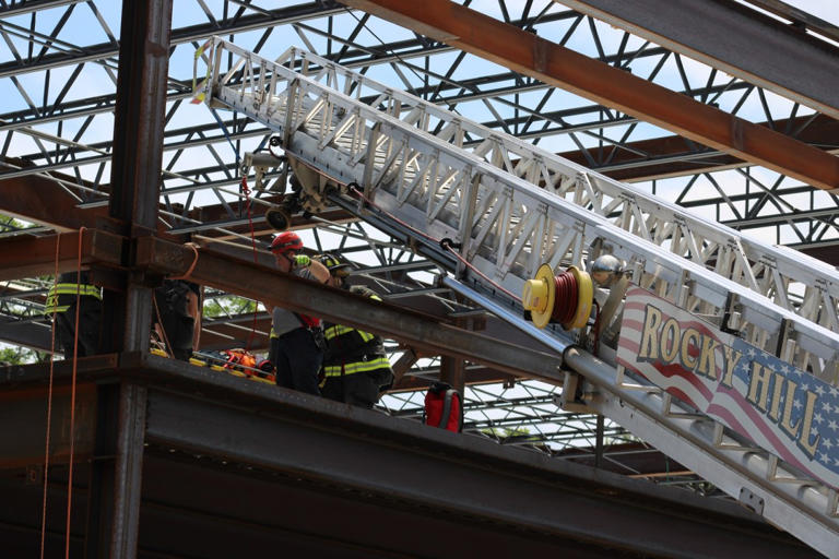 Photos: Person rescued after falling off construction site roof in ...