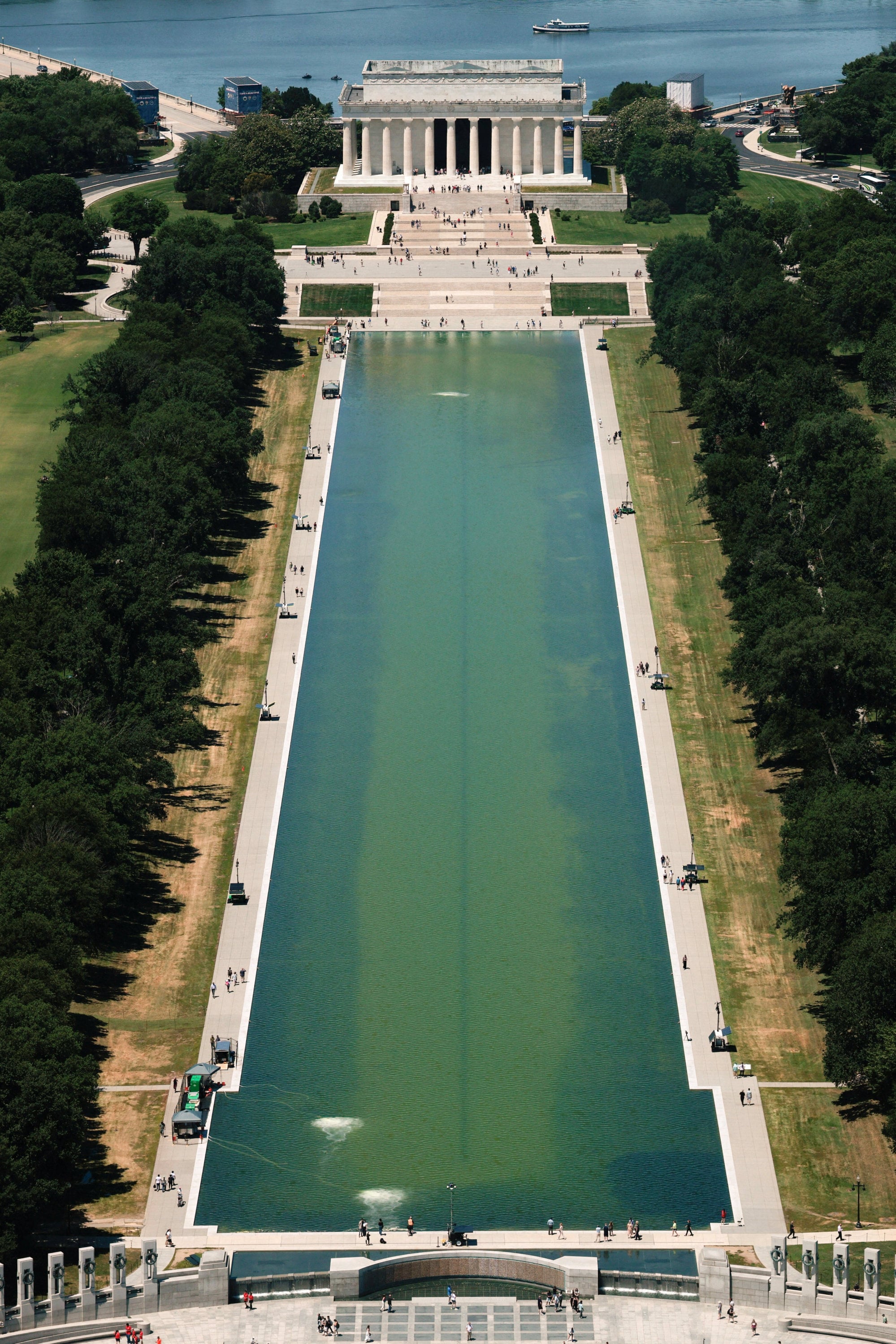 American flag blue? Algae turns Trump’s reflecting pool swamp green instead