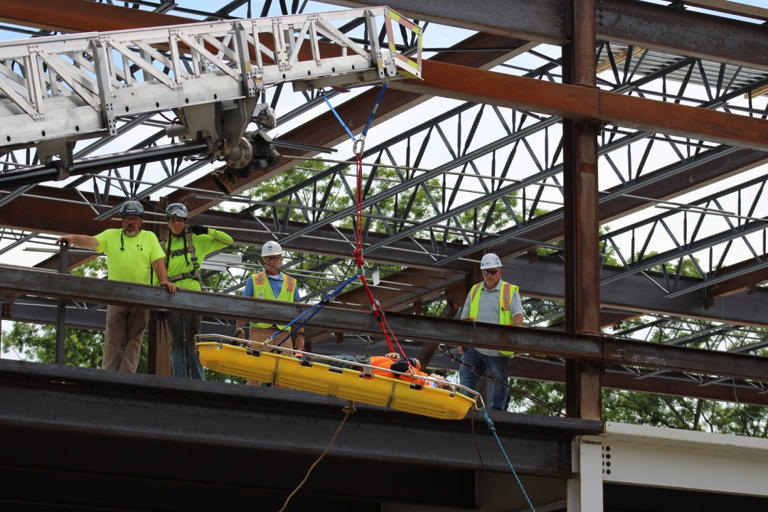 Photos: Person rescued after falling off construction site roof in ...