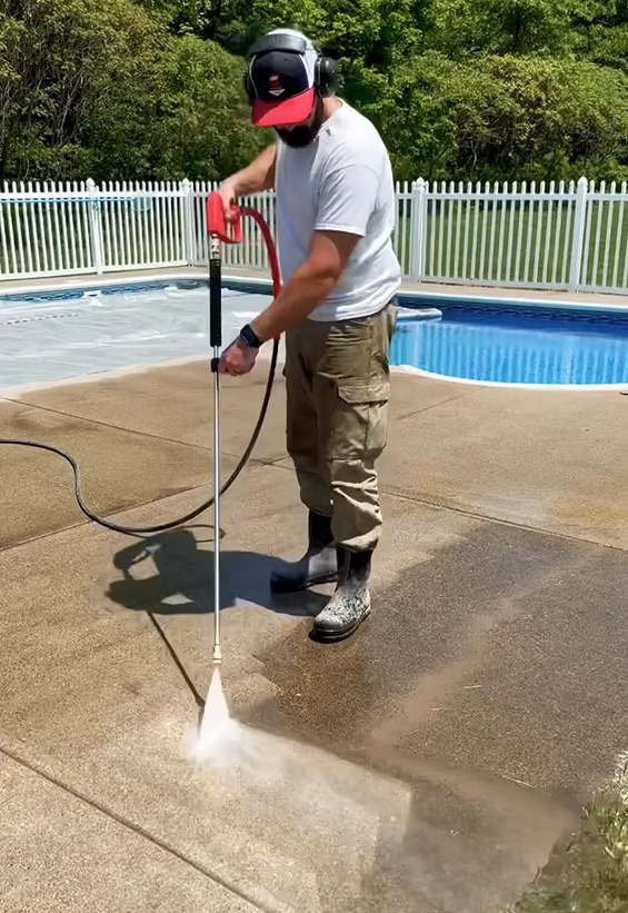 Powerwashing heavily dirty concrete and restoring it to a clean surface