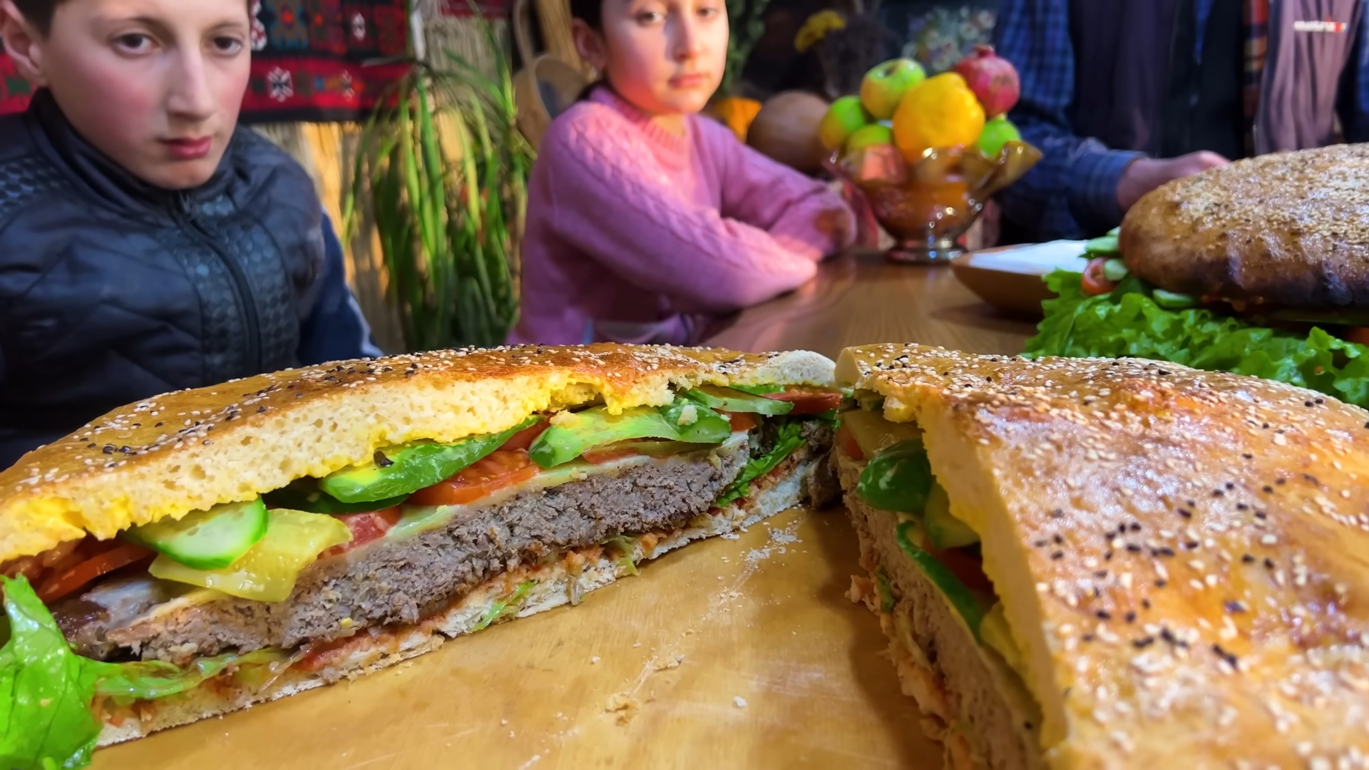How a massive beef burger is cooked from scratch in a village setting