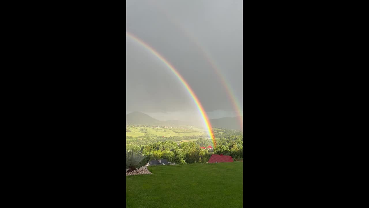 Double rainbow appears beneath stormy skies in Krakow, Poland
