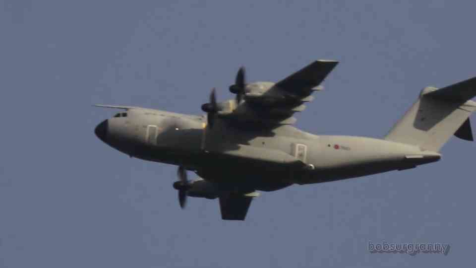 Watch a heavy transport fly by - then the strange prop sound turns heads