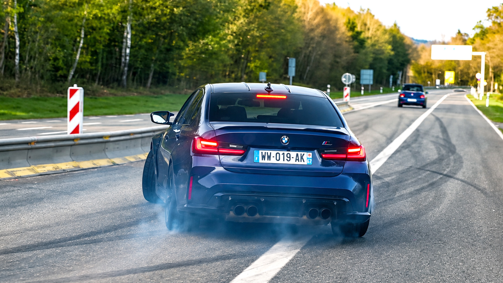 BMW driver shows drift skill while leaving a car meet