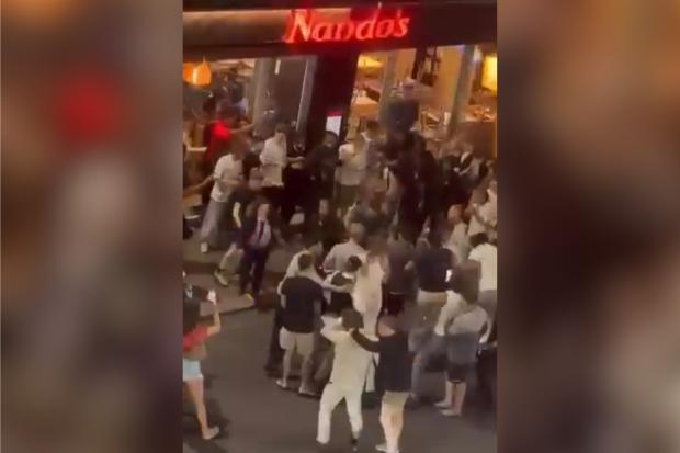 Shocking footage shows mass brawl with men kicked to floor outside ...