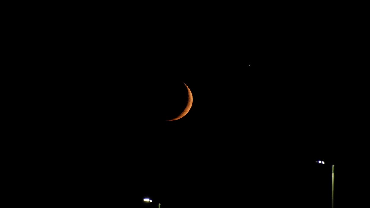 Beautiful orange crescent moon with Venus above London
