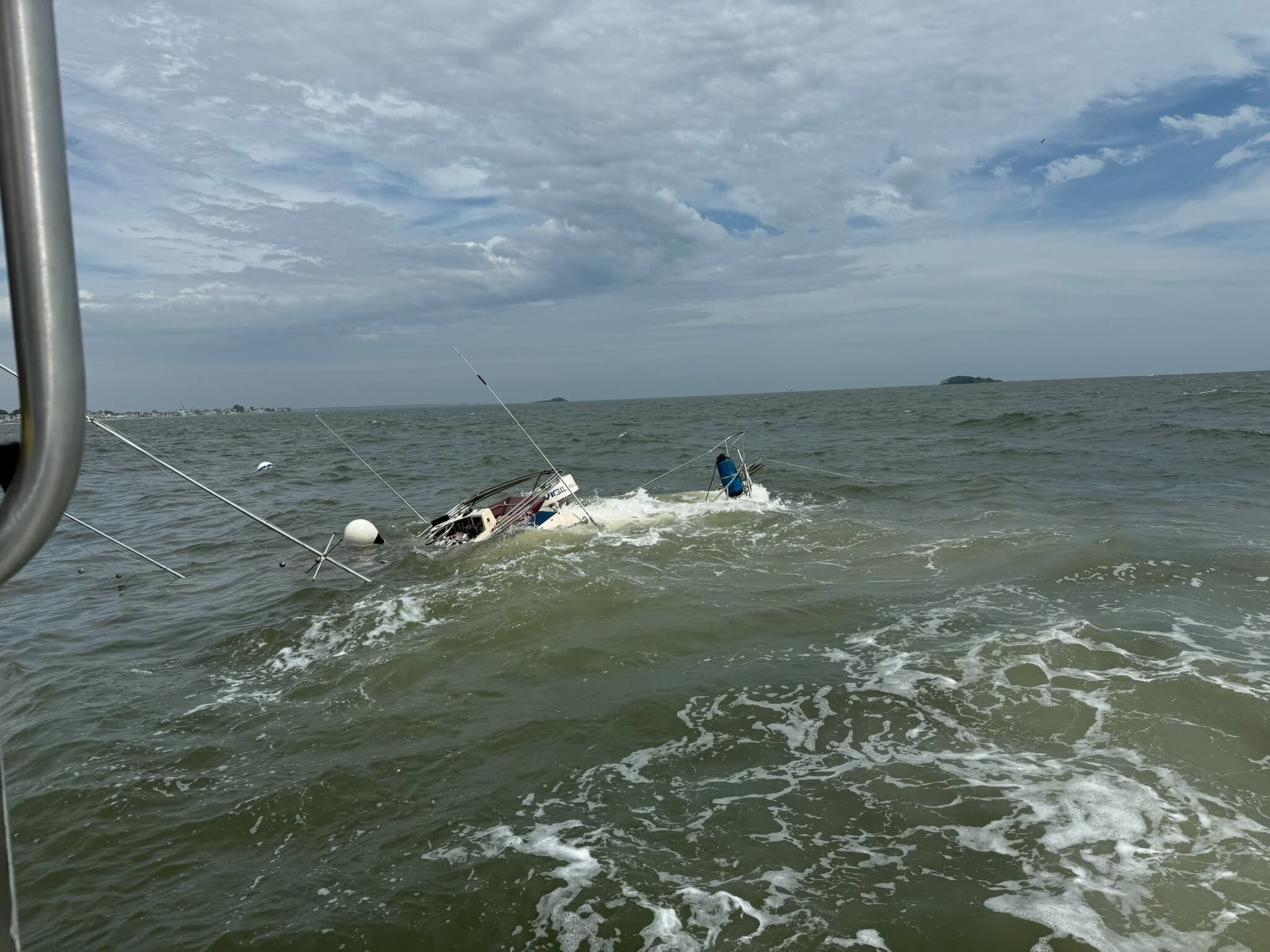 Emergency crews respond to sunken boat off Shore Road in Clinton