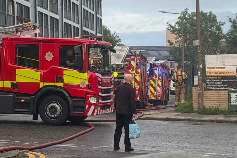 Emergency services swarm Edinburgh street amid ongoing building fire