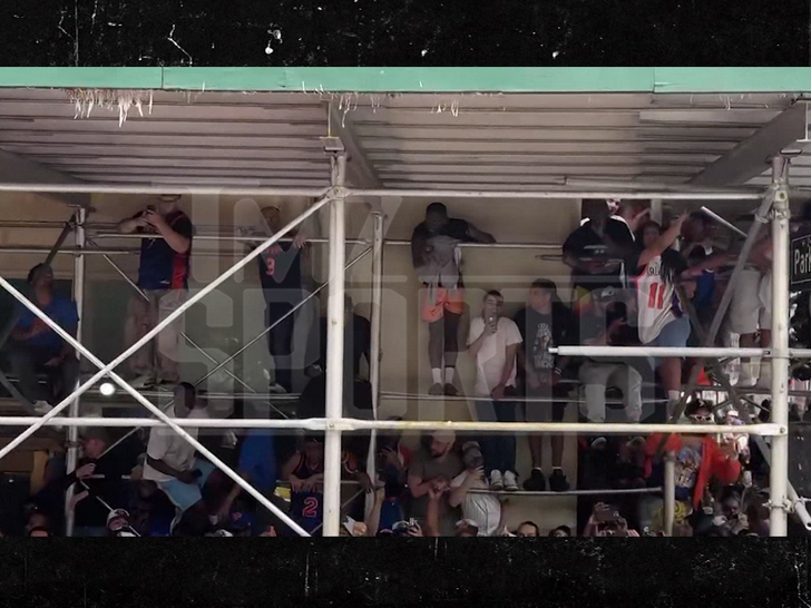 New York Knicks madness, fans climb scaffolding, lamp posts for view of ...
