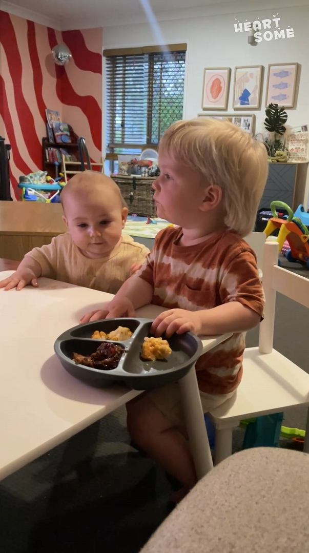 Hungry baby hilariously tries to steal food from toddler brother