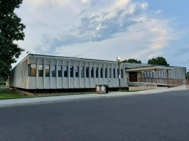 Brick aims to buy triangle lot that led to zoning board lawsuit