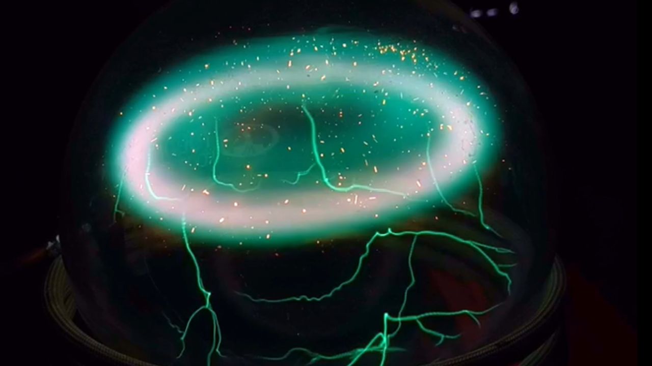 Plasma swirls like a nebula inside a glass globe