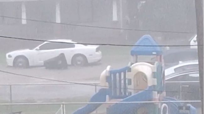 Garbage can floats down street during flash flooding in Missouri