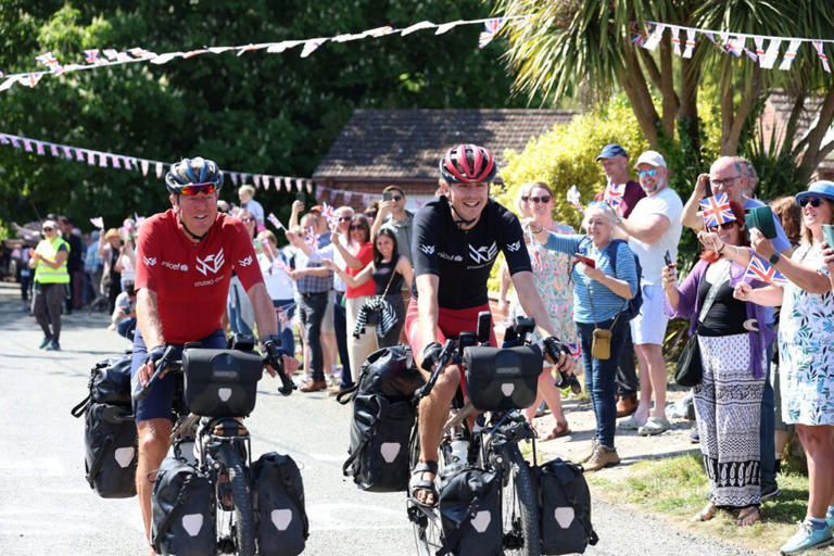 Father and son break world records after 18,000-mile cycle around the world