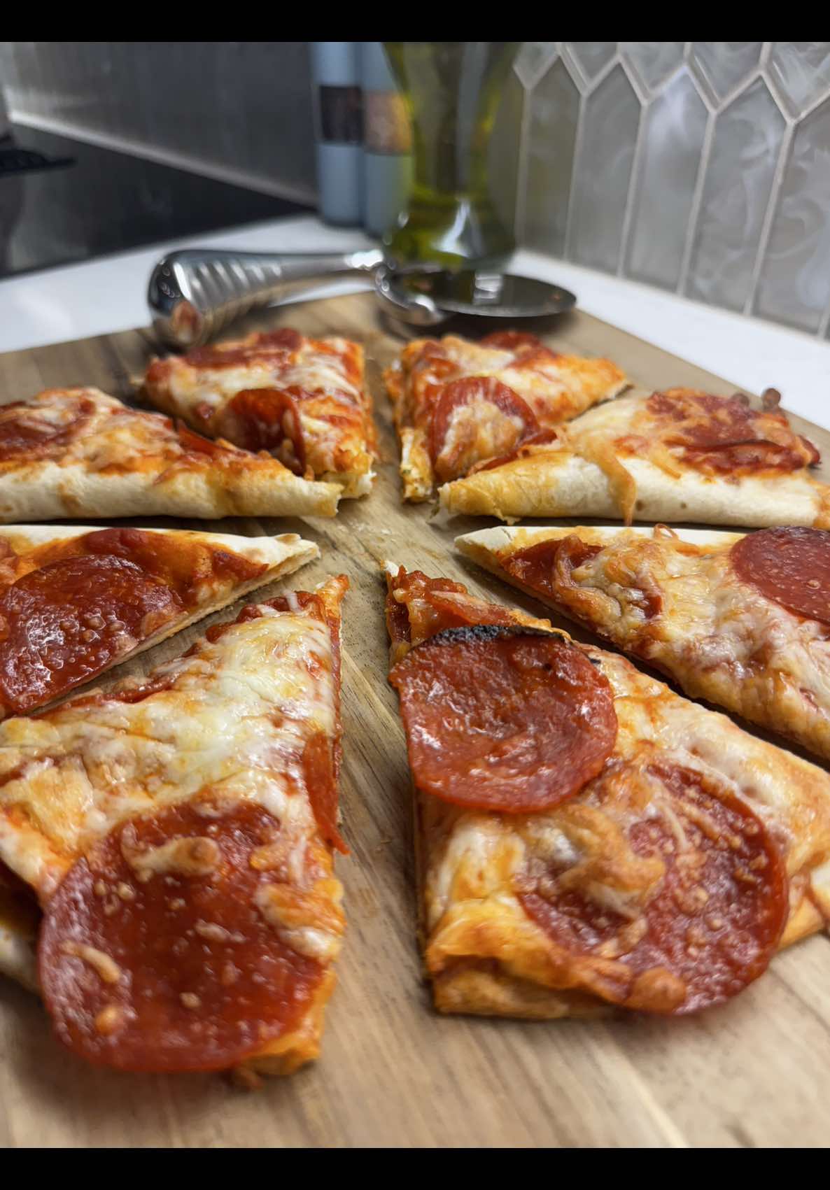 Delicious homemade pepperoni pizza sliced up fresh on a rustic wooden ...