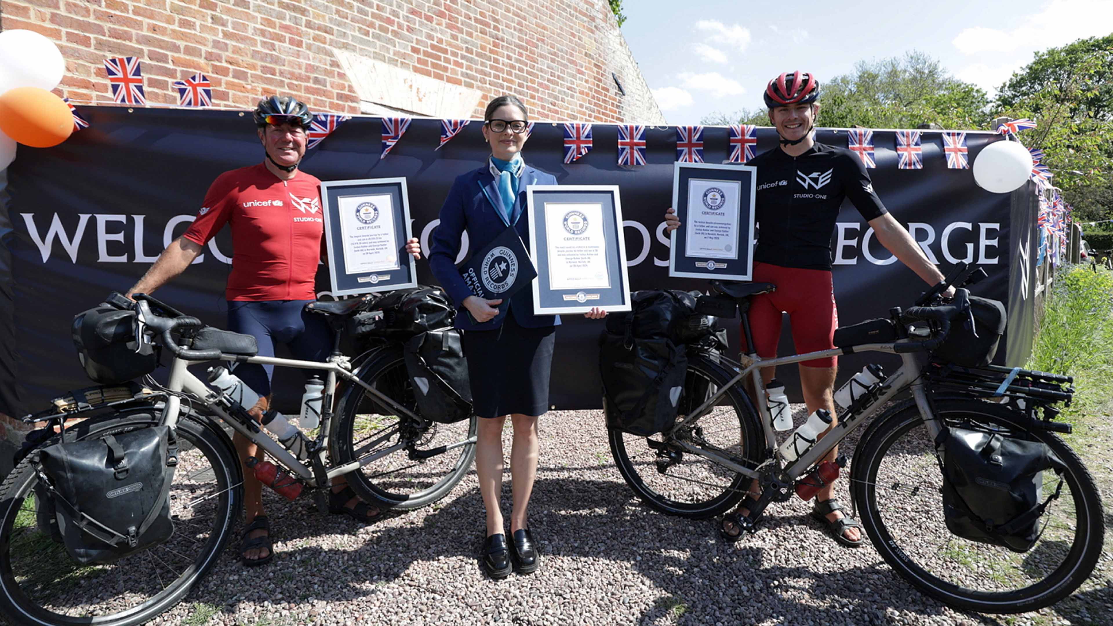 Father and son break three world records in 18,000 mile cycle around ...