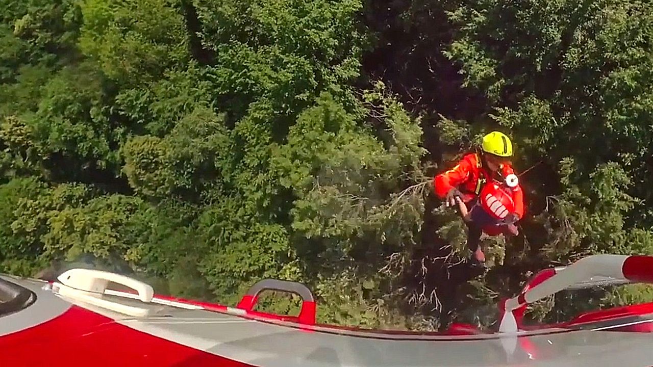 Helicopter crew winches stranded woman to safety from dense Italian ...