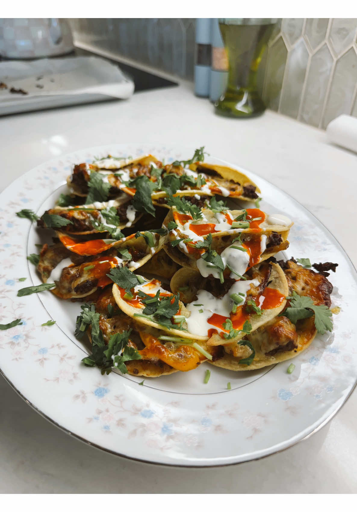 Homemade loaded mini tacos with melty cheese, creamy spicy sauce, and ...