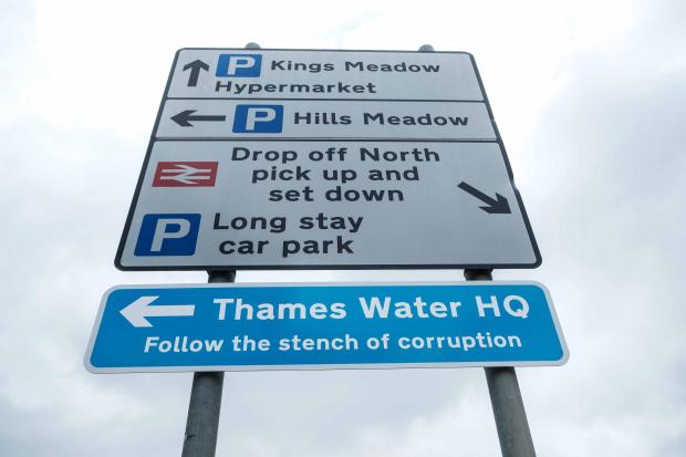 Protest sign outside Thames Water HQ calls company 'corrupt'