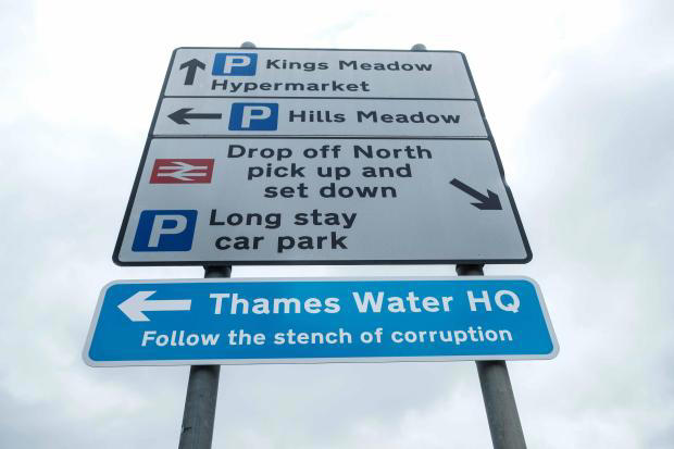 Protest sign outside Thames Water HQ calls company 'corrupt'