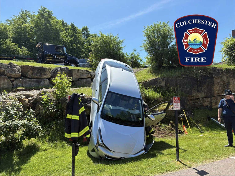 Driver uninjured after car rolls over small cliff in Colchester parking lot