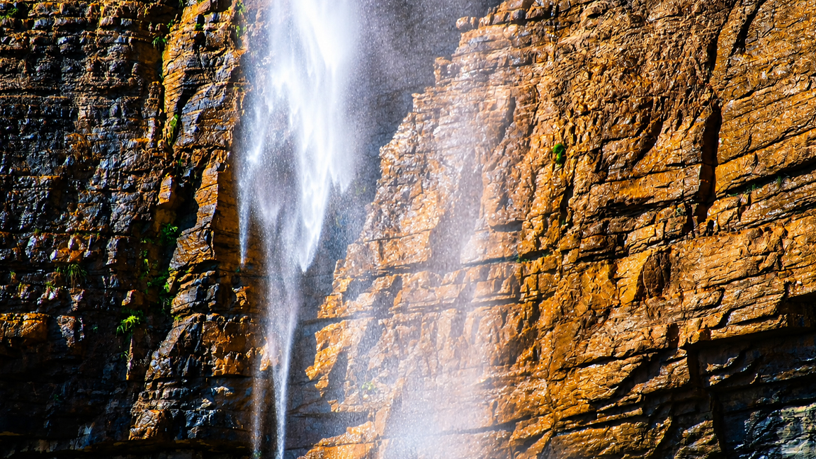 The hidden waterfall carved into ancient cliffs