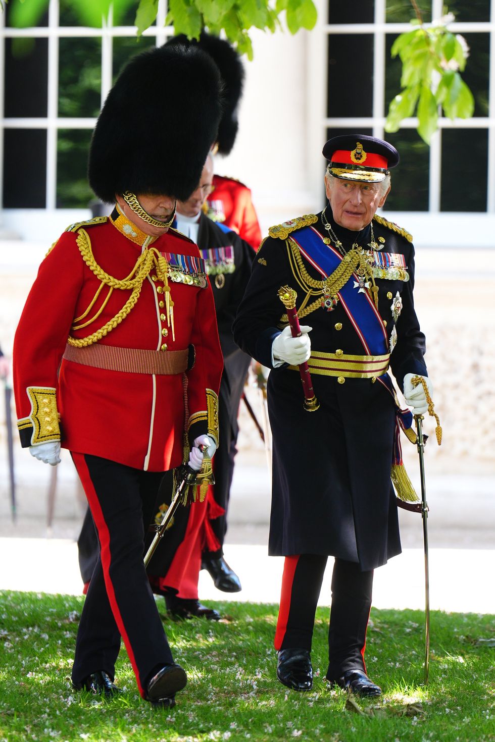 King Charles and Queen Camilla present new colours at Buckingham Palace
