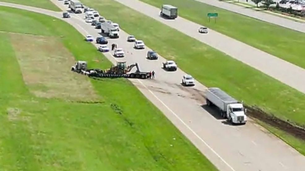 Semi crosses Highway 169 median, crashes into ditch after tire blow out