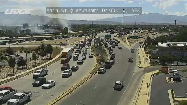 Crews fighting grass fire off I-15 near Pioneer Crossing in American Fork