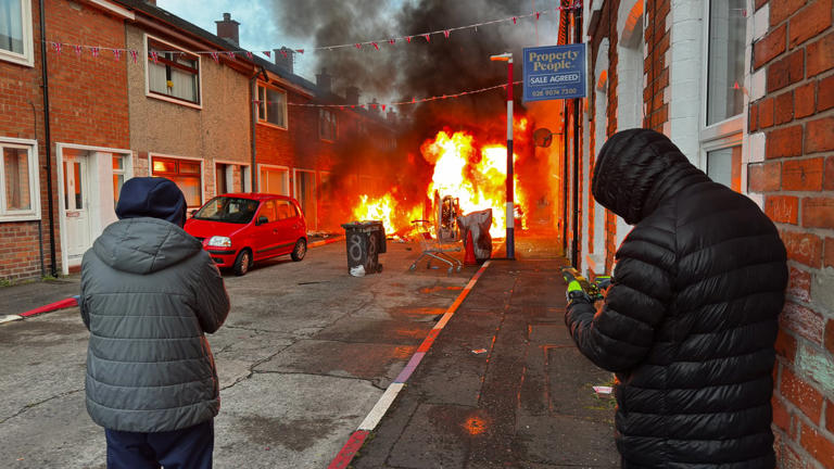 Homes set on fire as disorder erupts in Belfast after knife attack