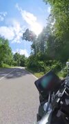 Rider slams into roadside wall and falls into water