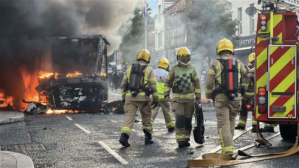 Belfast bus set on fire as hundreds protest after Sudanese migrant ...