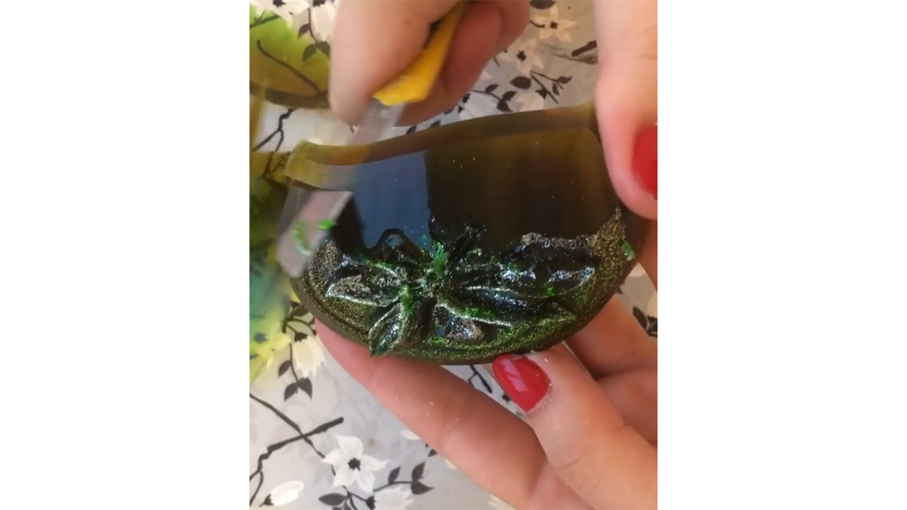 Satisfying slicing glossy emerald green soap revealing sparkling floral ...