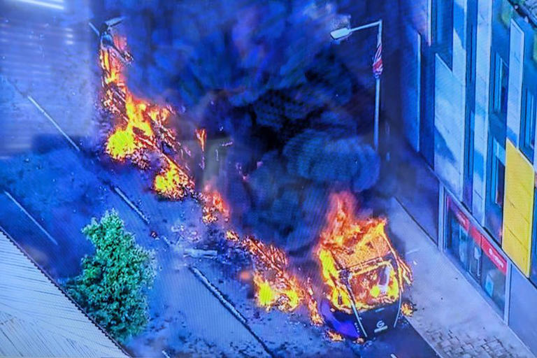 Bus set on fire as Belfast anti-immigration protest erupts after stabbing