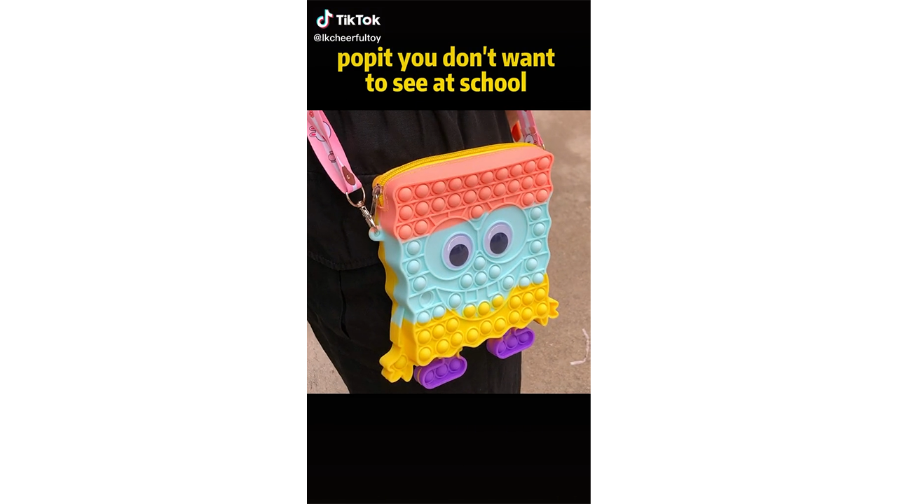 Showing giant pop it backpacks with colorful bubble designs