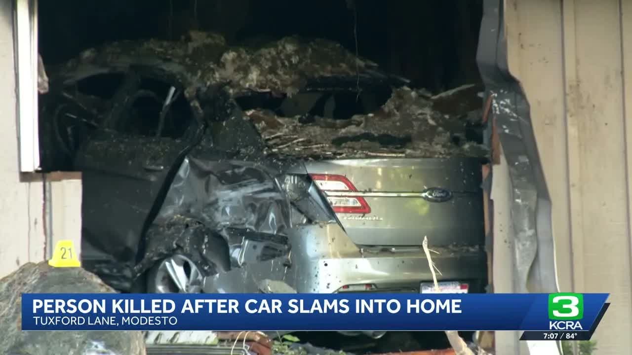 Person killed after car slams into home in Modesto