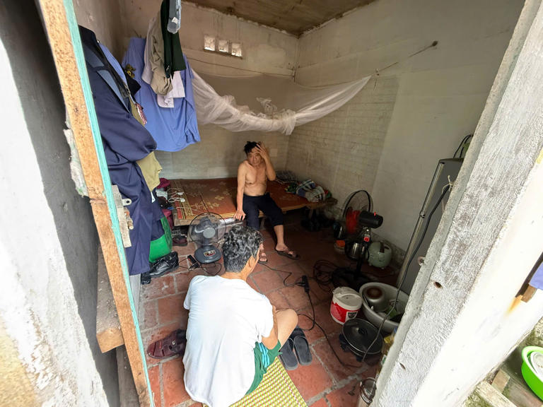 Hanoi factory workers endure 40°C heat in cramped rental rooms without ...