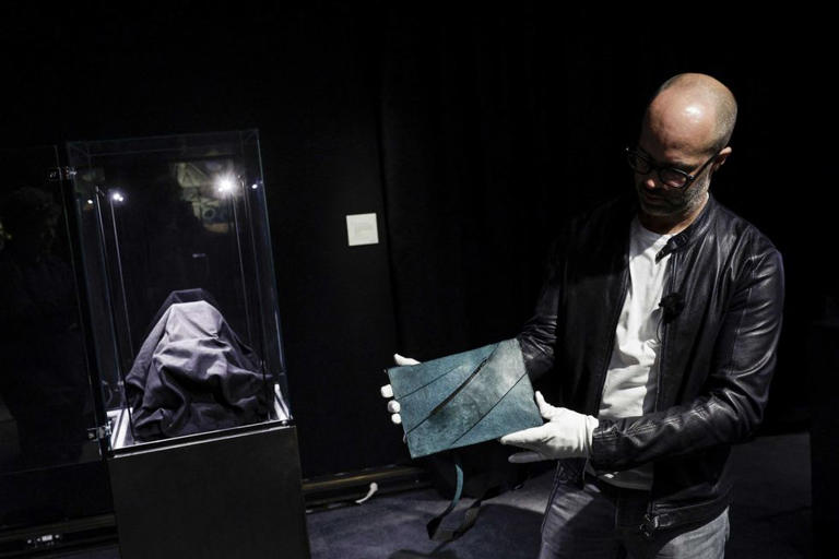 Is this the world's oldest bag? 'T-Rex' leather clutch is about to go ...