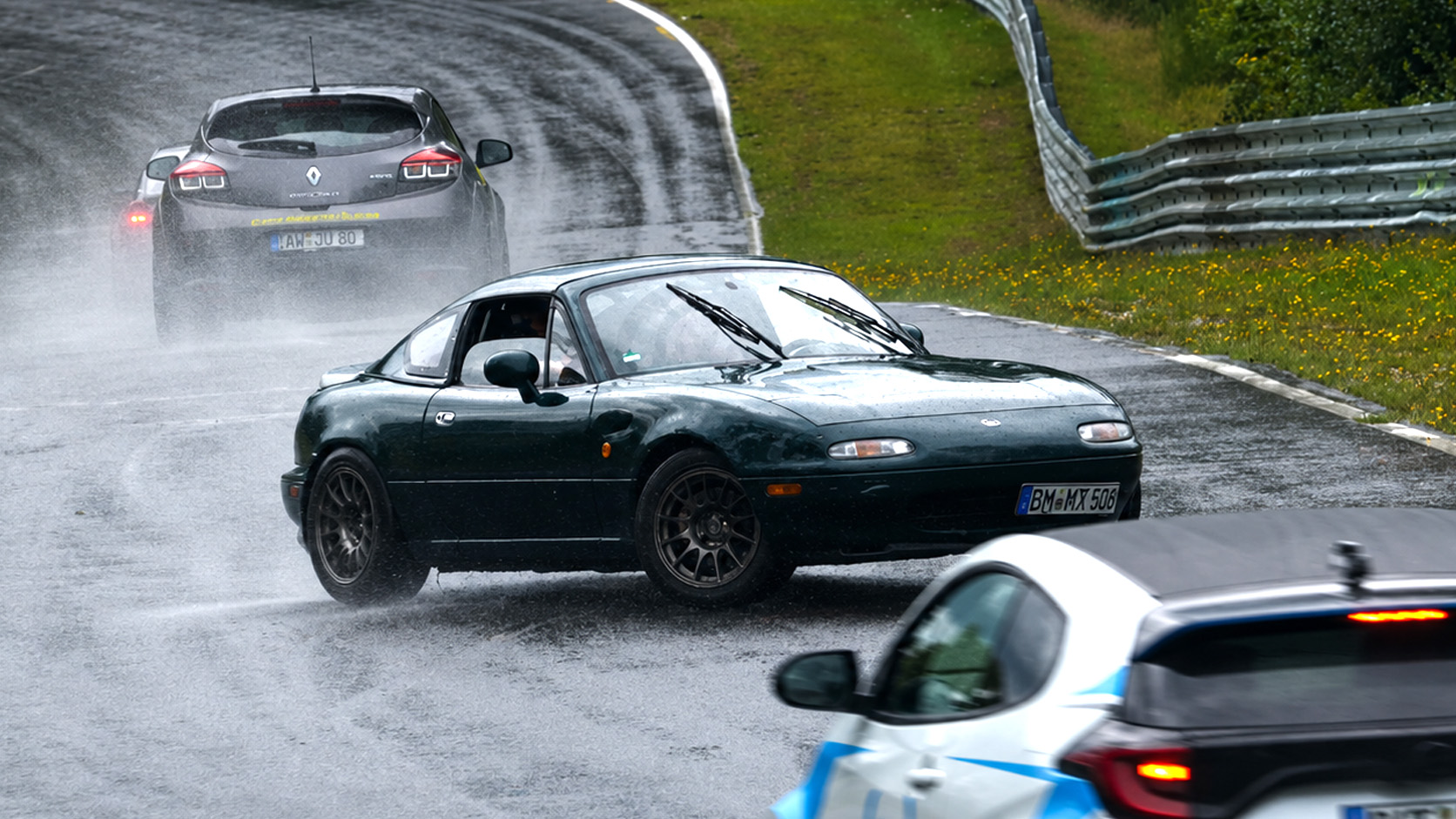 Mazda Miata loses control in wet conditions creating a terrifying close ...