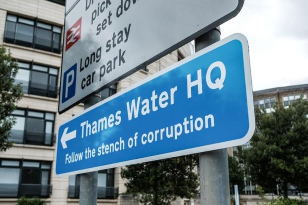 Artist puts 'follow the stench of corruption' sign at Thames Water ...