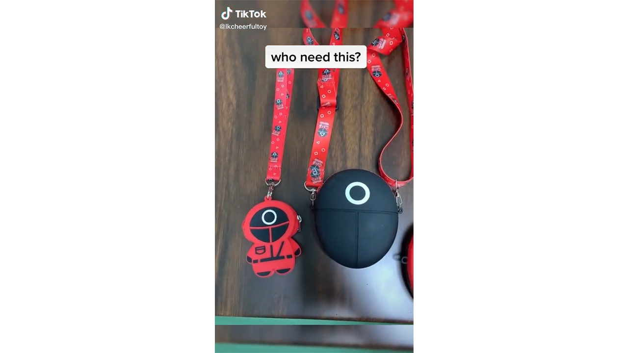 Showing a Squid Game inspired pop it bag with stylish red lanyard