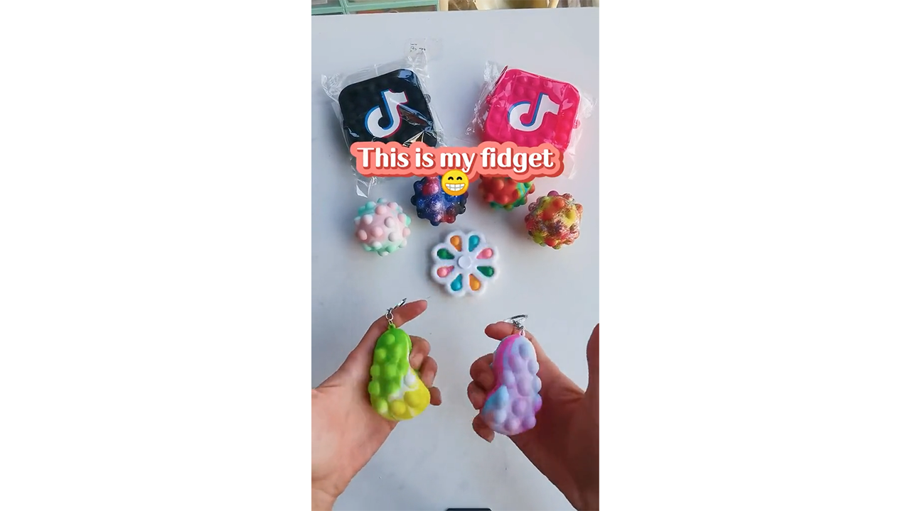 Showing a colorful TikTok pop it collection with cute sensory fidgets