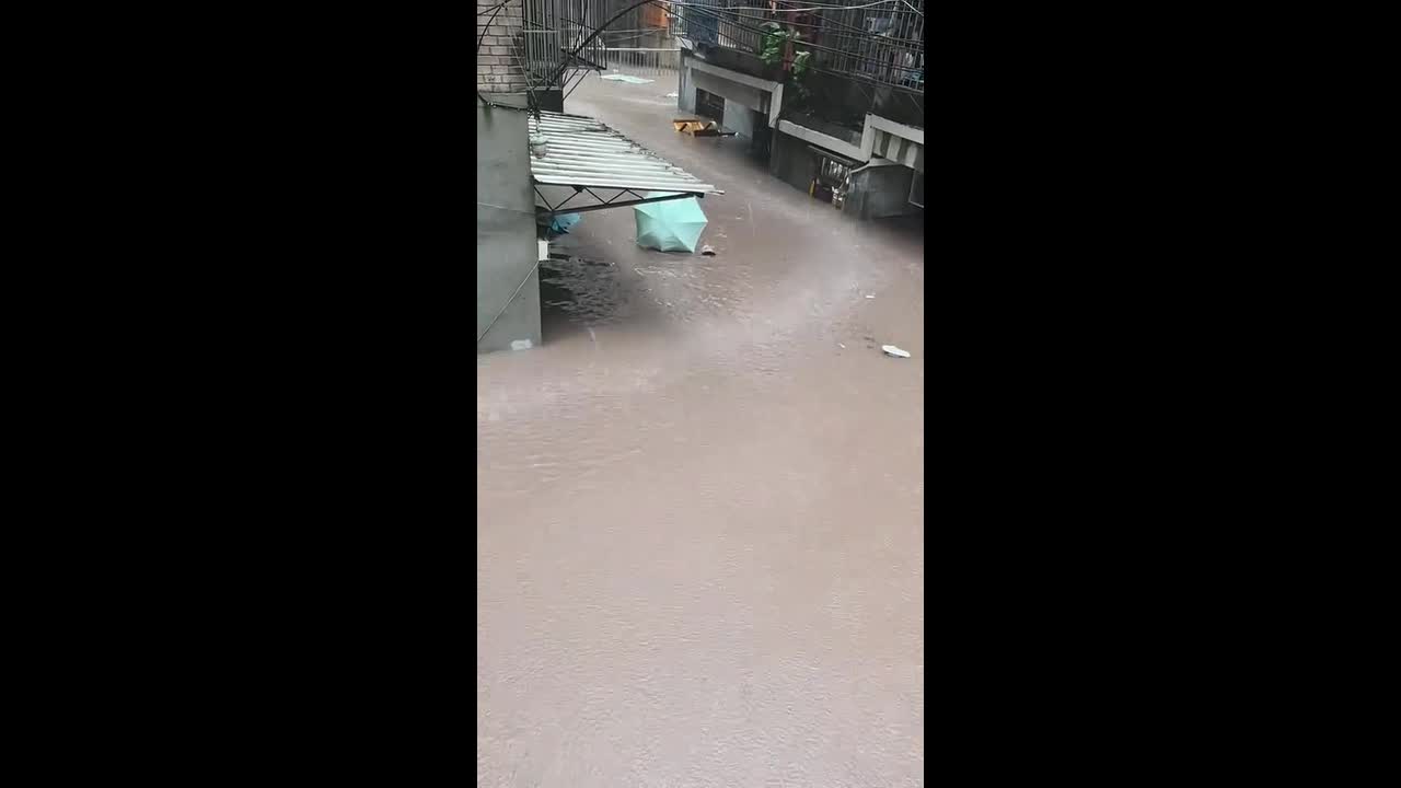 Man swims through flooded street amid high water in Chongqing, China